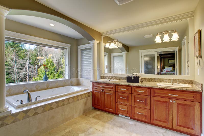 Elegant Master Bathroom with Window Above Bathtub. Stock Image - Image ...