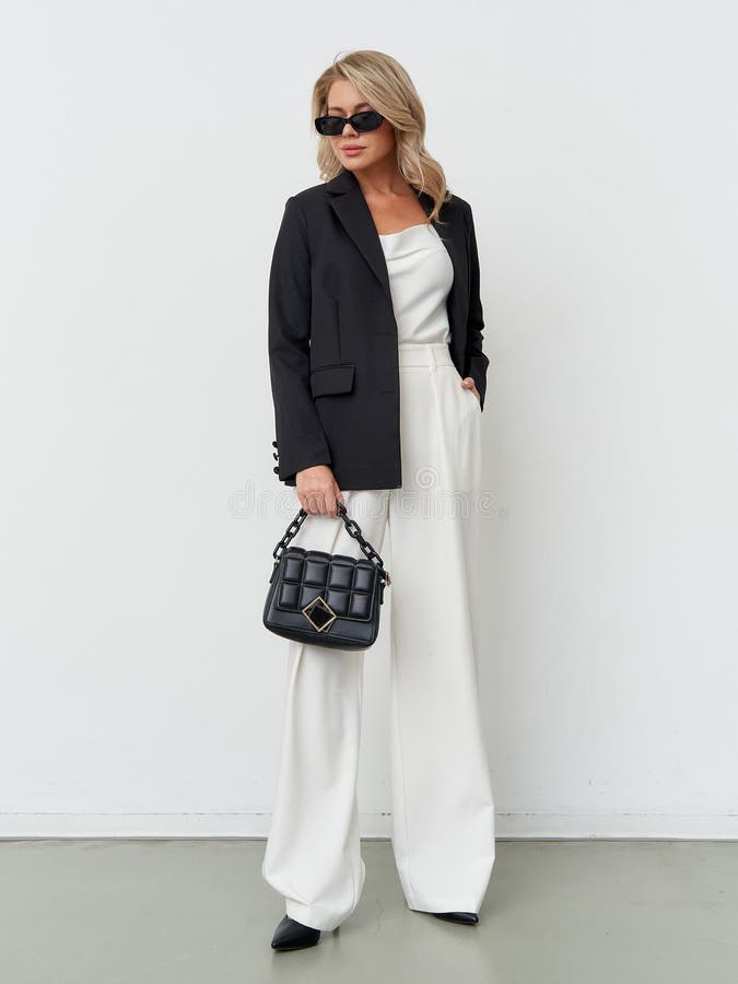 Elegant Model Posing in a Stylish Black and White Ensemble within a ...