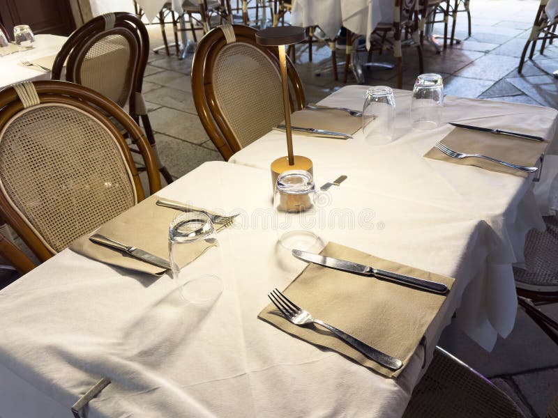 Elegant Outdoor Dining Setup with Table Setting and Wooden Chairs ...