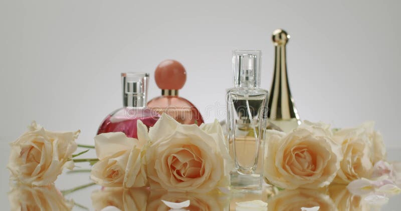 Elegant Perfume Bottles with Delicate Roses on Glass Surface Stock ...