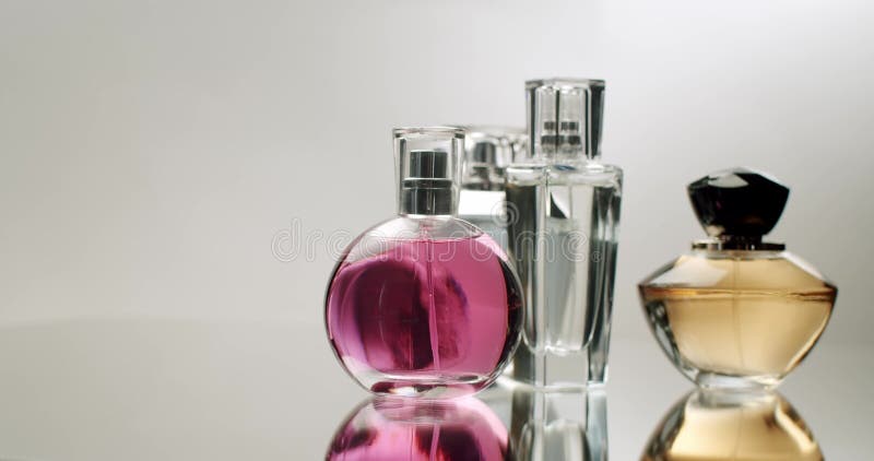 Elegant Perfume Bottles on Mirror Surface with Reflections Stock ...