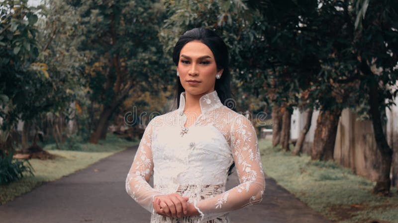 Elegant Person in a Lace Gown Posing on a Tree-lined Path Stock Footage ...