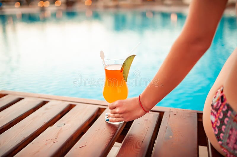 Beautiful Girl Drinking Cocktail Near Swimming Pool And Relaxing Stock