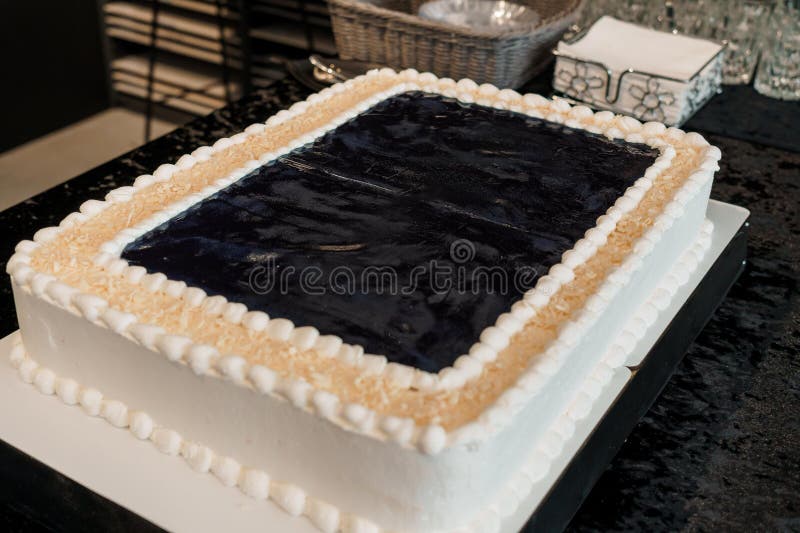Elegant Rectangular Cake with Blue Frosting and Delicate White Piping ...