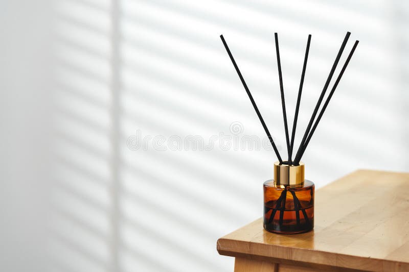 Elegant Reed Diffusers on Wooden Surface with Soft Background Light ...