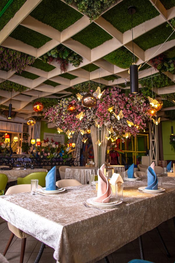 Elegant Restaurant Interior with Decorated Ceiling and Table Settings ...