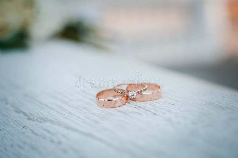 Elegant Rose Gold Wedding Rings on Rustic Surface Stock Image - Image ...