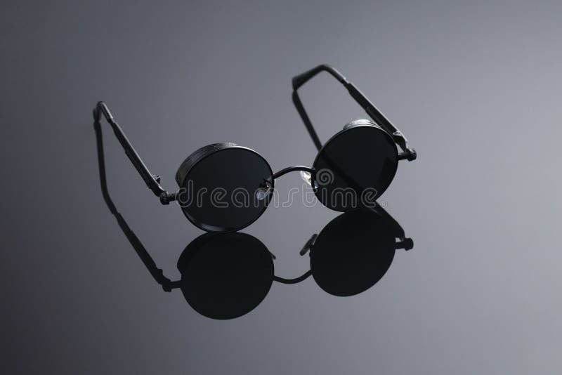 Elegant Round Sunglasses with Dark Lenses on Glass Background Stock ...