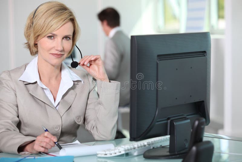 Elegant Secretary With Headset Royalty Free Stock Photo - Image: 18171115