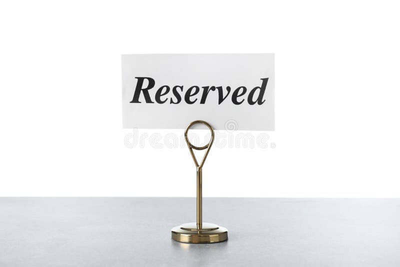 Elegant Sign Reserved on Light Grey Table Against White Background ...