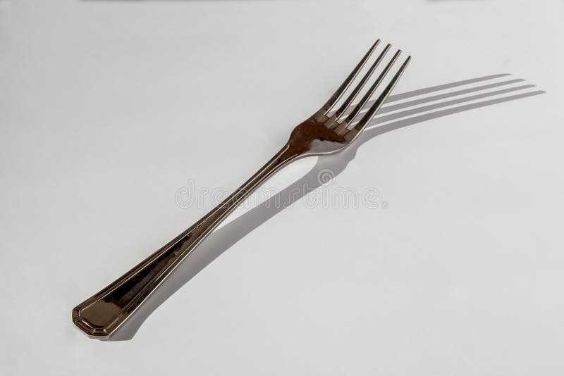 Elegant Stainless Fork on White Table with Sharp Sunny Shadow Stock ...