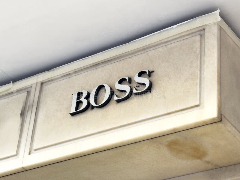 Elegant Storefront Signage with Bold Boss Logo on Stone Facade ...