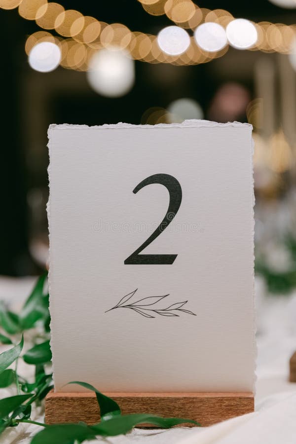 Elegant Table Number Two Stands Ready at an Event with Soft Lighting ...