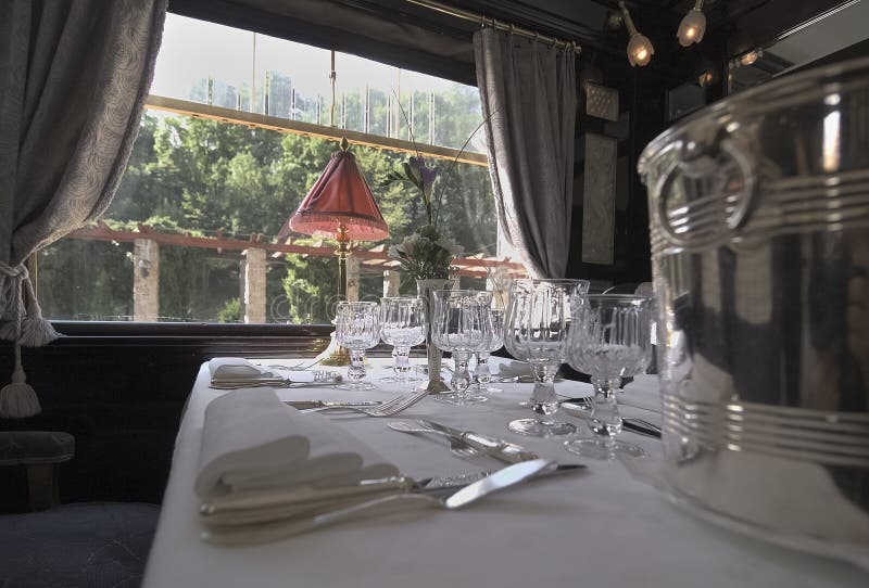 Elegant Table Setting with Crystal Glassware and Vintage Lamp Aboard ...