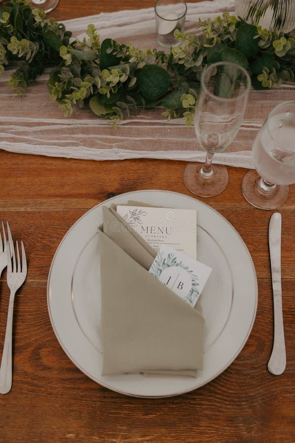 Elegant Table Setting with a Menu and Napkin on a White Plate ...