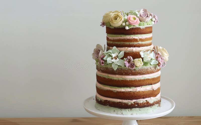 Elegant Three-Tier Floral Wedding Cake on Display Stock Image - Image ...