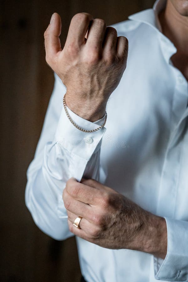 Elegant Touch: Man Adjusting Cufflinks with Grace and Style Stock Photo ...