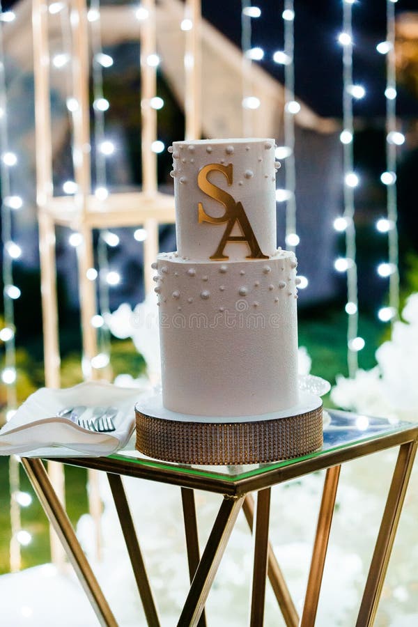 Elegant Two-Tiered Wedding Cake with Gold Monogram and Sparkling ...