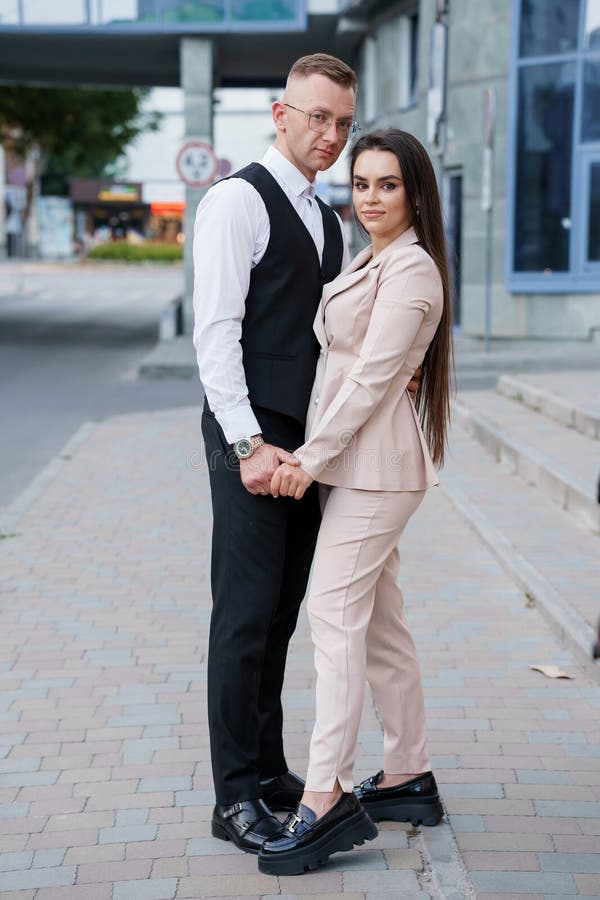 Elegant Urban Couple Embracing in Modern Attire Stock Photo - Image of ...