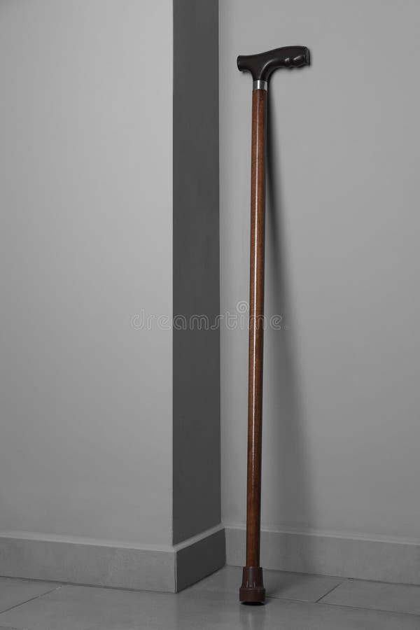 Elegant Walking Cane Near Light Grey Wall Indoors Stock Image - Image ...