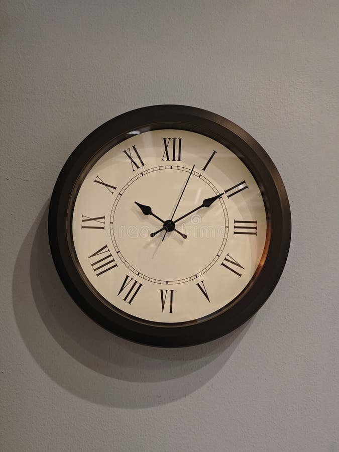 Elegant Wall Clock with Roman Numerals on Subtle Grey Background Stock ...