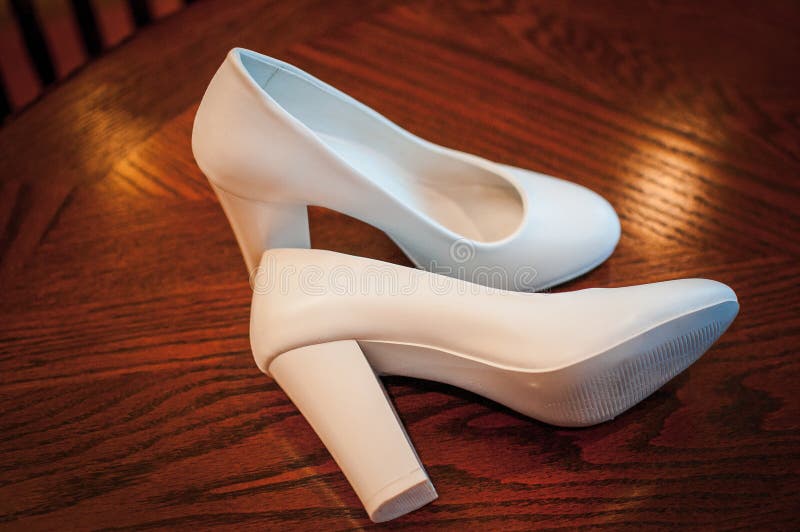 Elegant White High Heels Displayed on a Wooden Table Stock Image ...