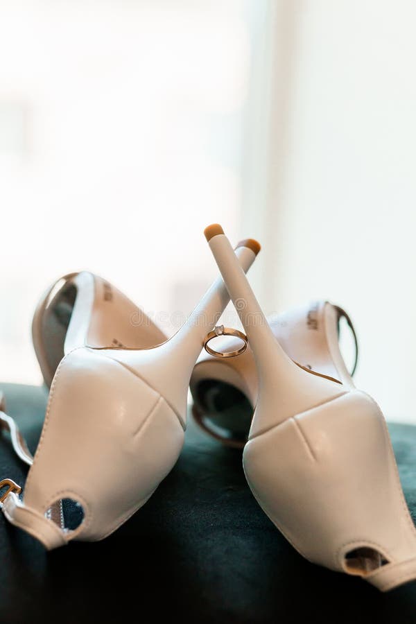 Elegant White High Heels with Wedding Ring on Display Stock Photo ...