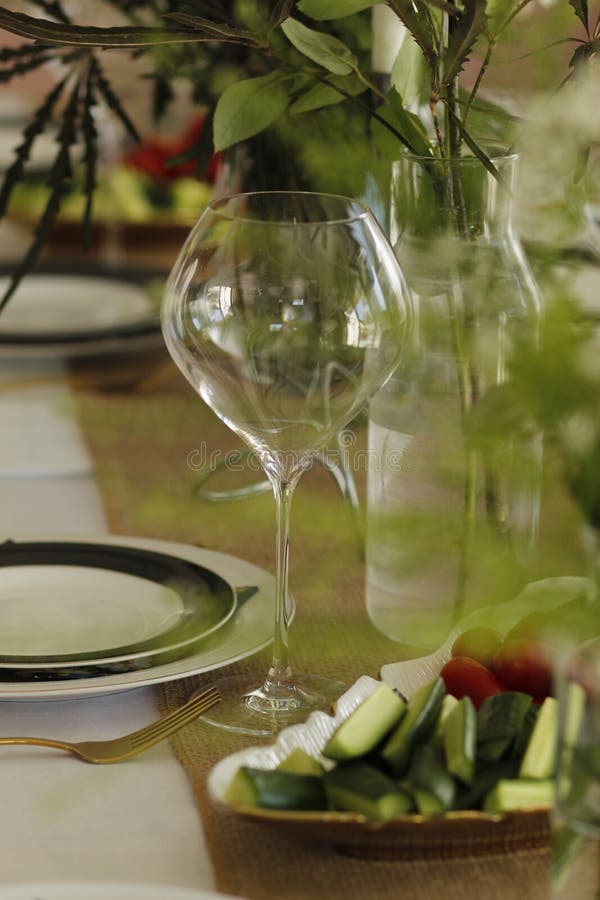 Elegant Wine Glass and Table Setting with Greenery and Reflection Stock ...