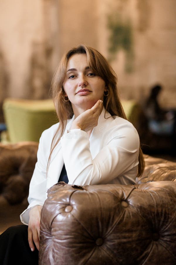 Elegant Woman Posing Thoughtfully in a Cozy Cafe Setting Stock Photo ...