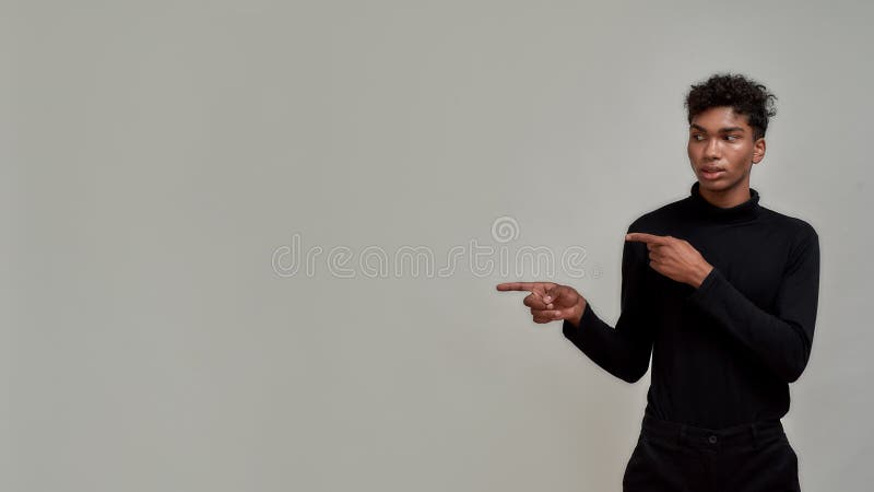 Elegant Young Guy with Piercing Dressed in Black Looking and Pointing ...
