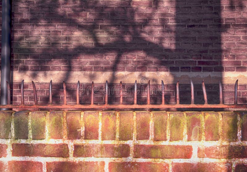 Element of a Brick Fence with Metal Spikes on a Background of an Old ...