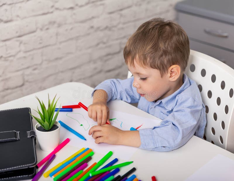 Elementary Boy Learning at Home. Cute Cheerful Child Drawing Stock ...