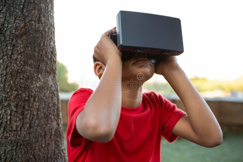 Elementary Boy Using Virtual Reality Headset at Park Stock Image ...