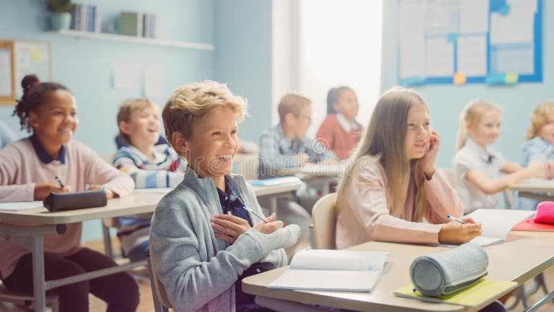 Elementary Classroom of Diverse Bright Children Laugh Together after ...