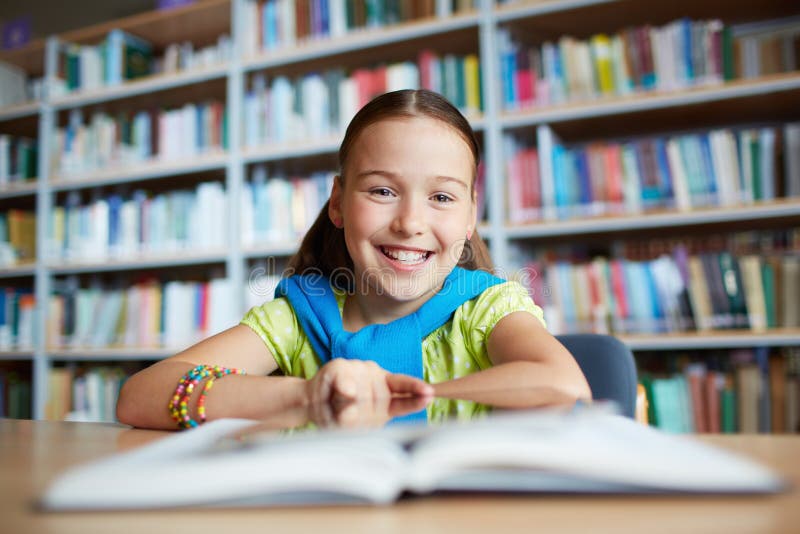 Cute Pupils Smiling at Camera in Library Stock Photo - Image of ...