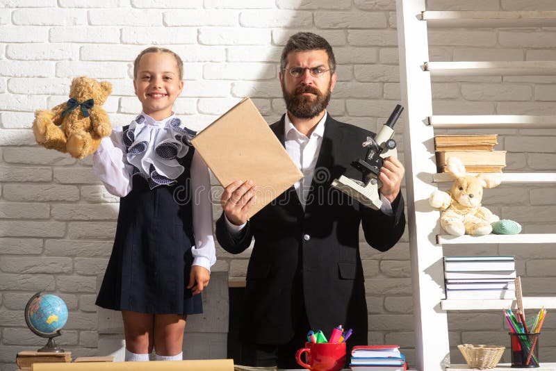 Elementary Pupil with Teacher in Classroom. Teacher with a Young ...