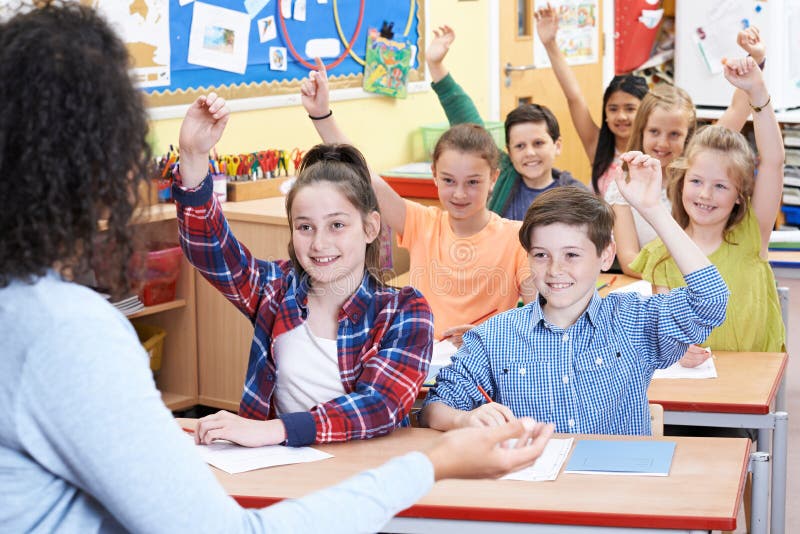 Elementary Pupils Answering Question in Class Stock Image - Image of ...