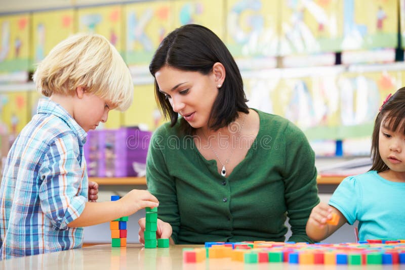 Elementary Pupils Counting with Teacher in Classroom Stock Photo ...