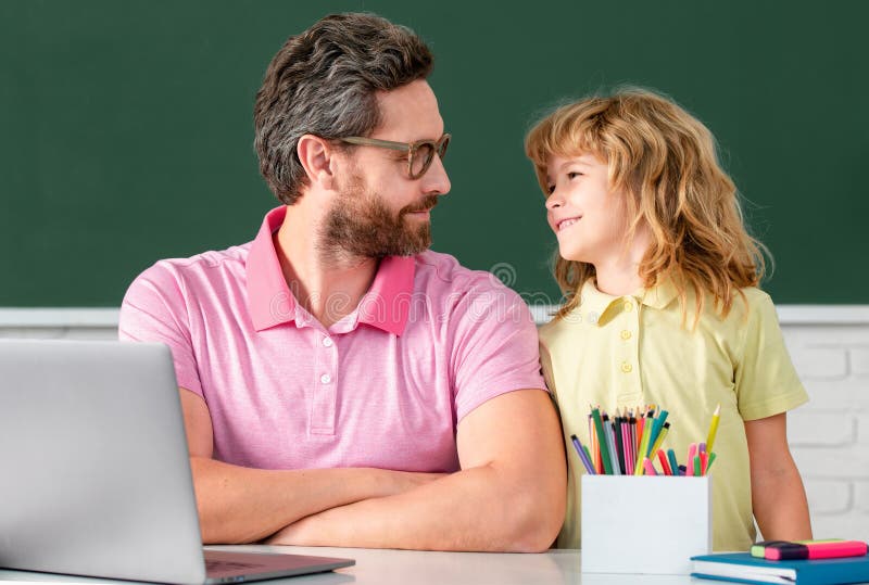 Elementary School Boy in Classroom on Lesson. Teacher Explaining To ...