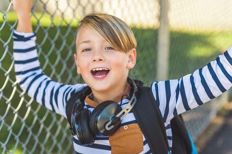Elementary School Boy Outside Carrying a Backpack Stock Image - Image ...