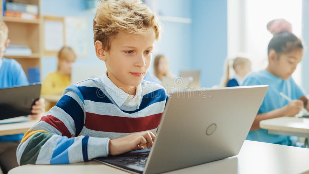 Elementary School Computer Science Class: Smart Boy Uses Laptop ...