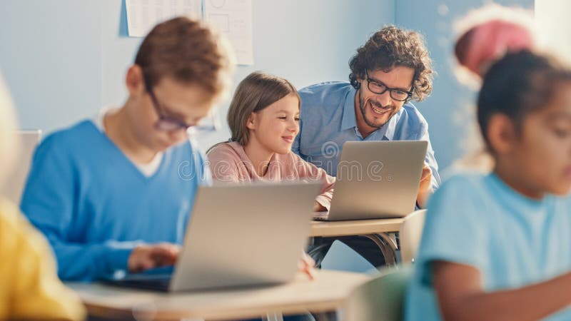 Elementary School Computer Science Class: Smart Girl Uses Laptop ...