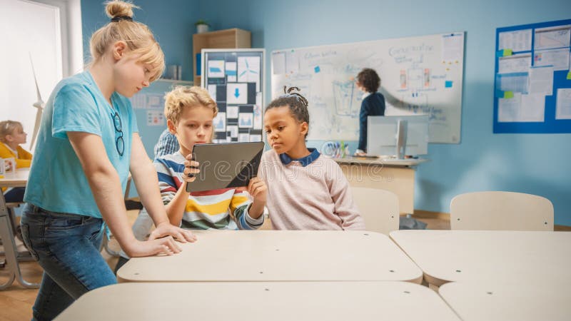 Elementary School Computer Science Class: Two Girls and Boy Use Digital ...