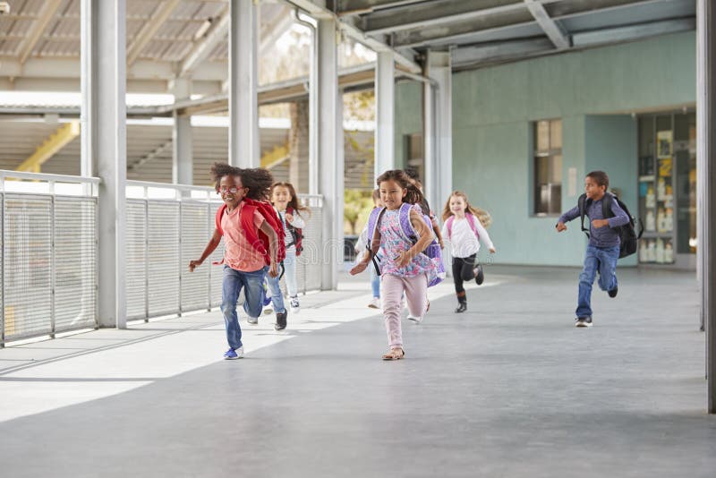 Elementary School Kids Running in School Corridor, Side View Stock ...