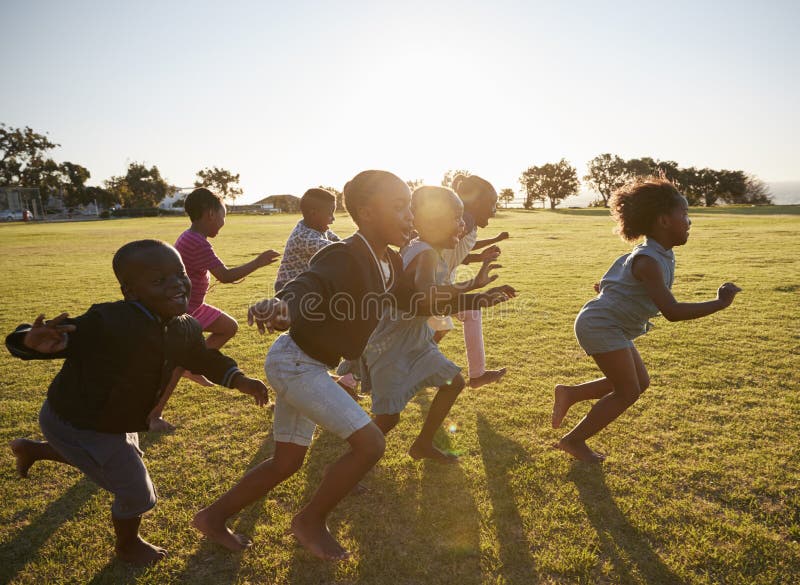 Elementary School Kids Running Together in an Open Field Stock Photo ...