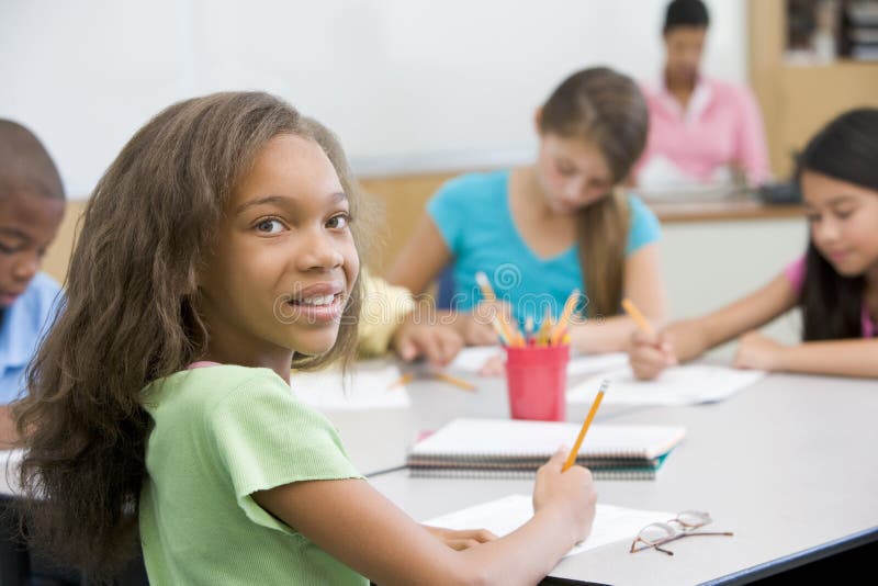 Elementary School Pupil in Classroom Stock Photo - Image of book ...