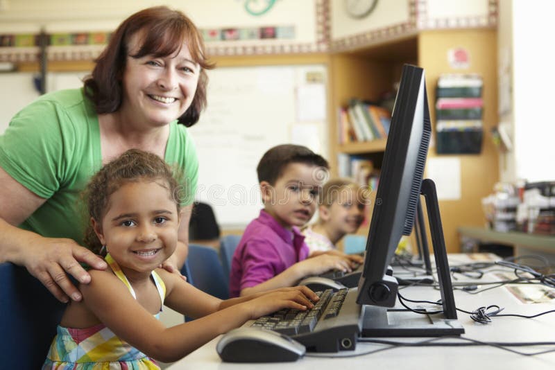 Elementary School Pupil with Teacher in Computer Class Stock Photo ...