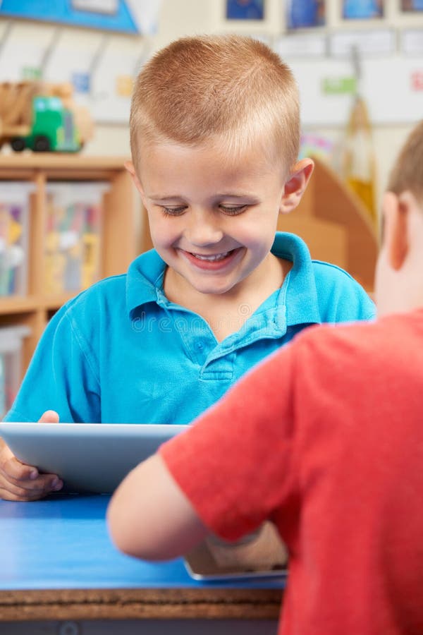 Elementary School Pupil Using Digital Tablet in Classroom Stock Photo ...