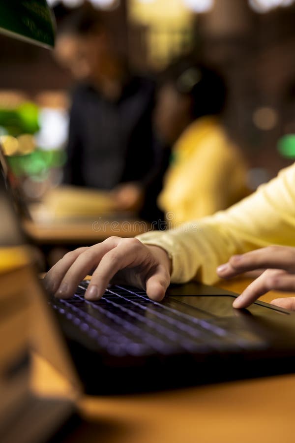 Elementary School Pupil Writing Essay on Her Laptop Using Library Books ...