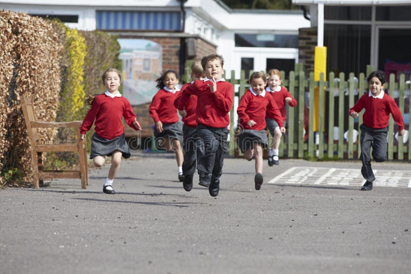 Elementary School Pupils Running in Playground Stock Image - Image of ...